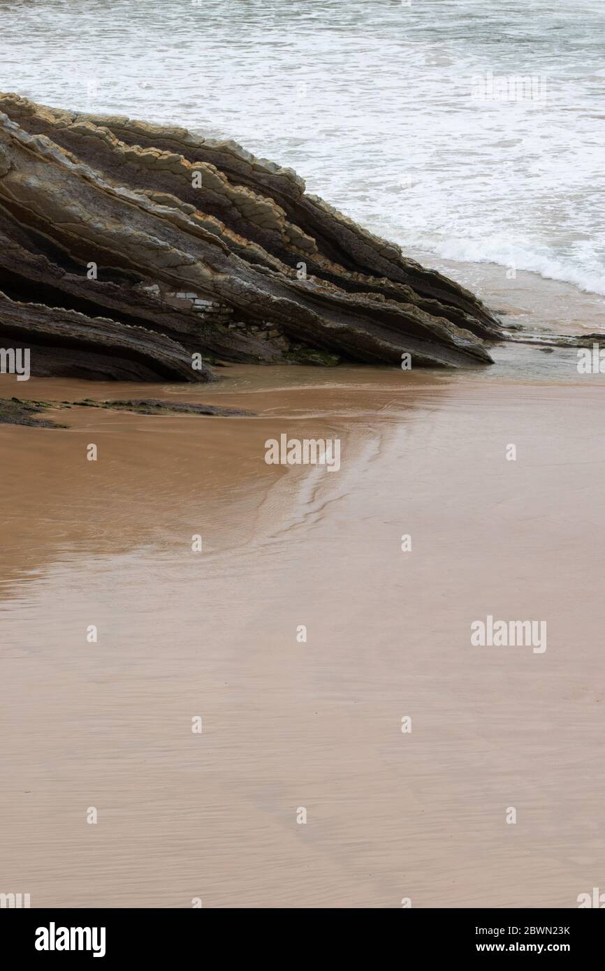 Rock formation in the middle of the beach Stock Photo - Alamy