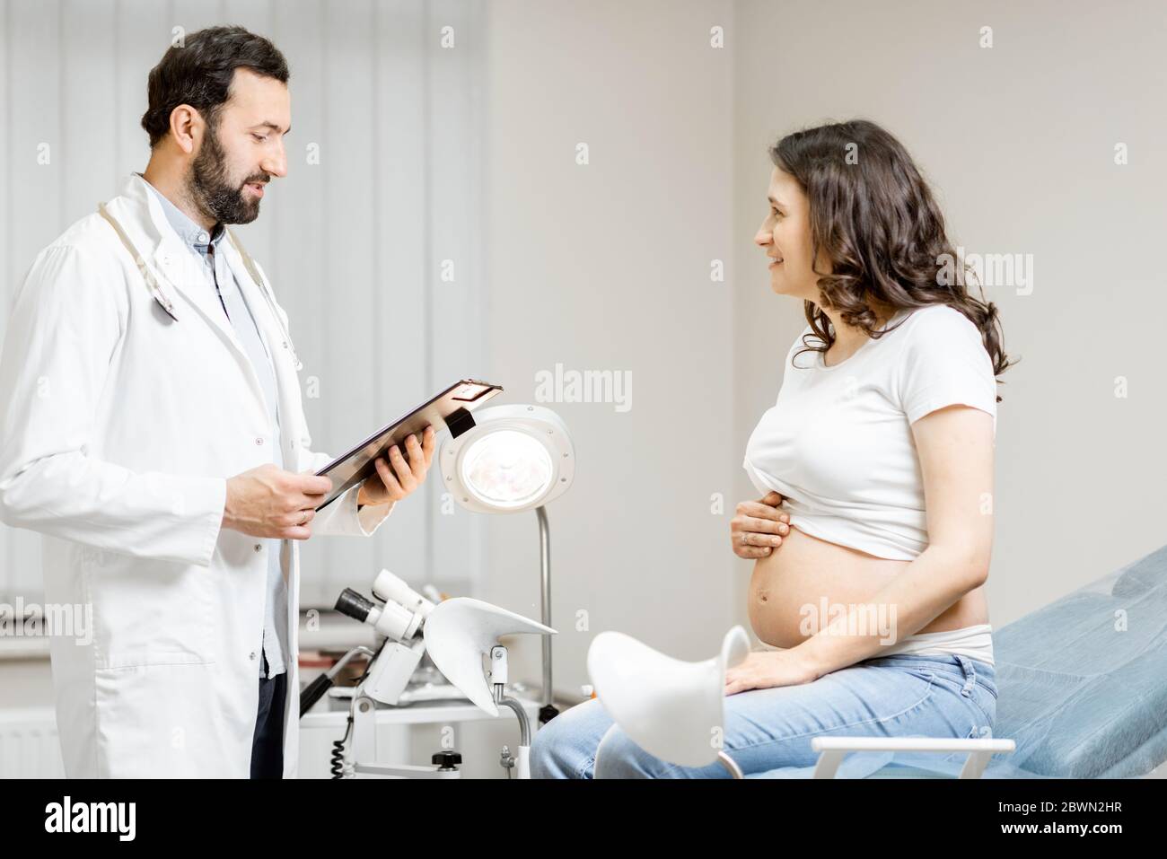 Doctor with pregnant woman during a medical consultation in ...