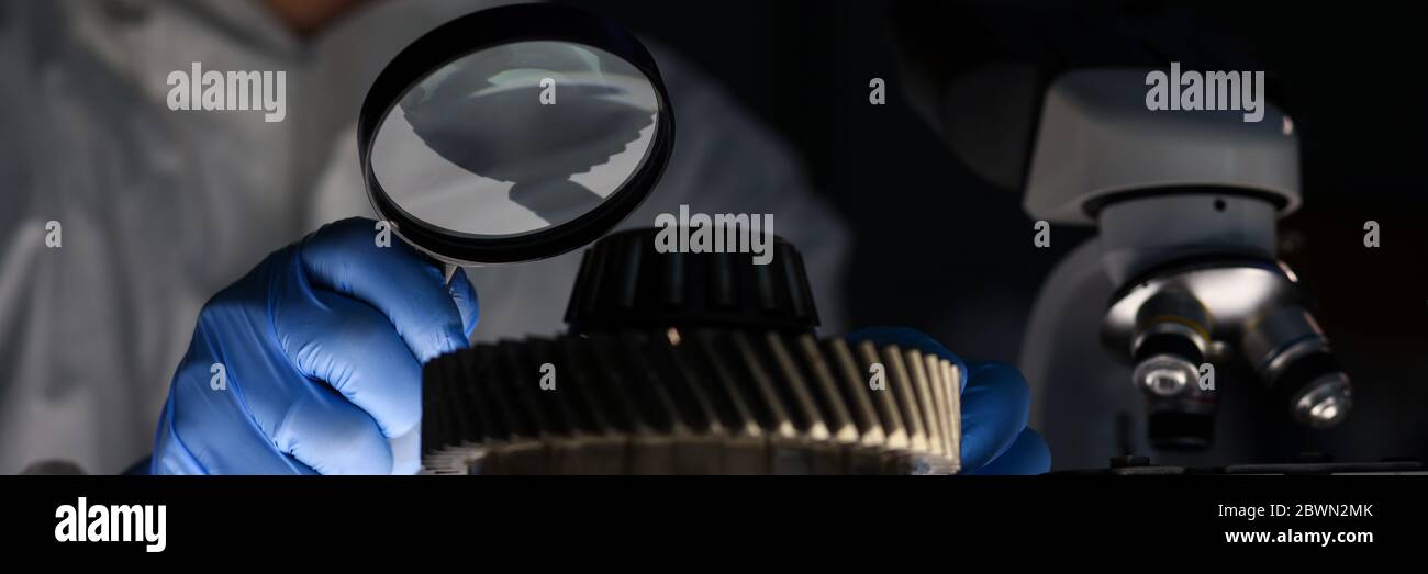 Man in lab examines parts of vehicle Stock Photo - Alamy