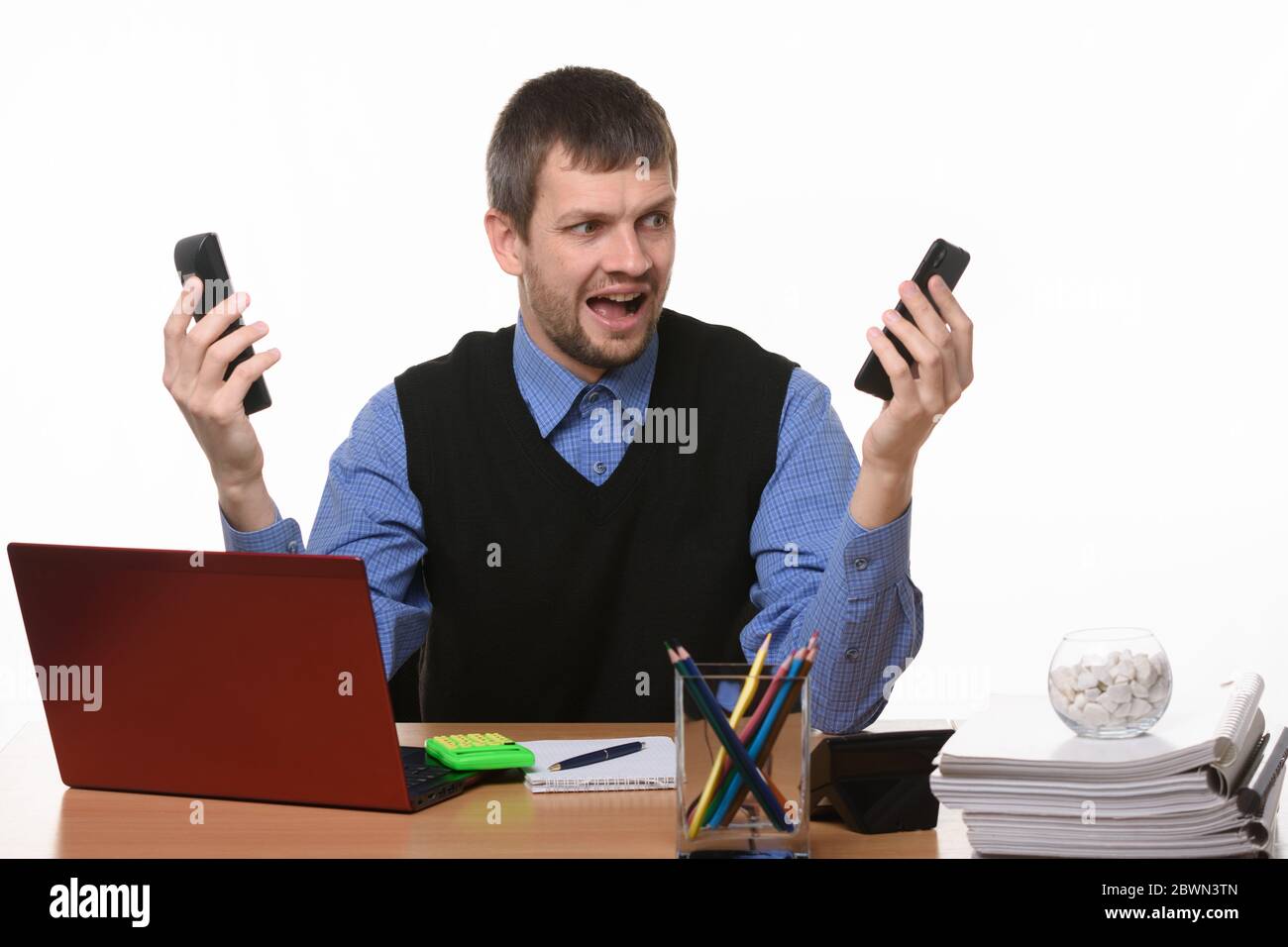 man with two phones in shock looks at them Stock Photo - Alamy