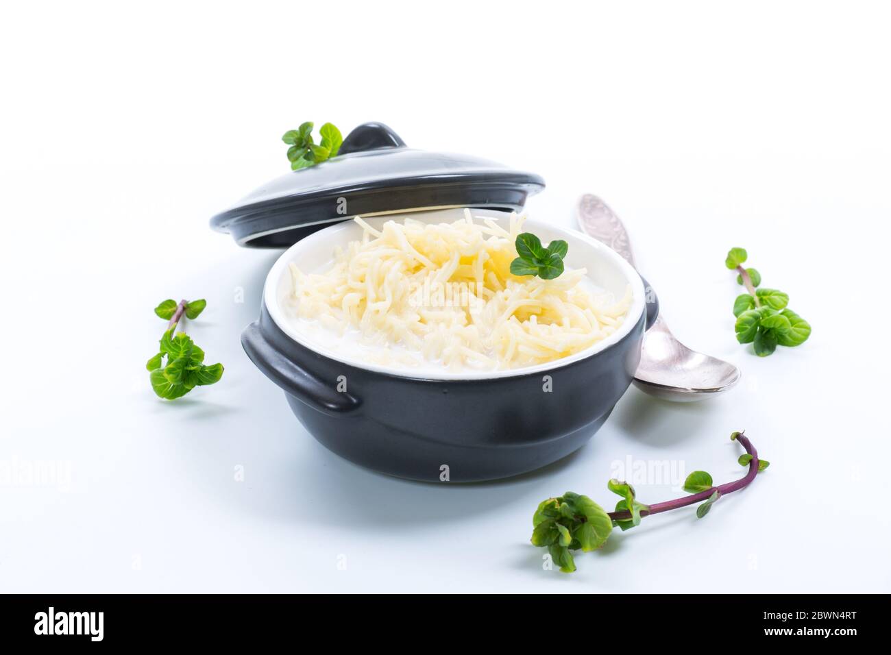 sweet boiled vermicelli with milk in a ceramic bowl isolated on white ...