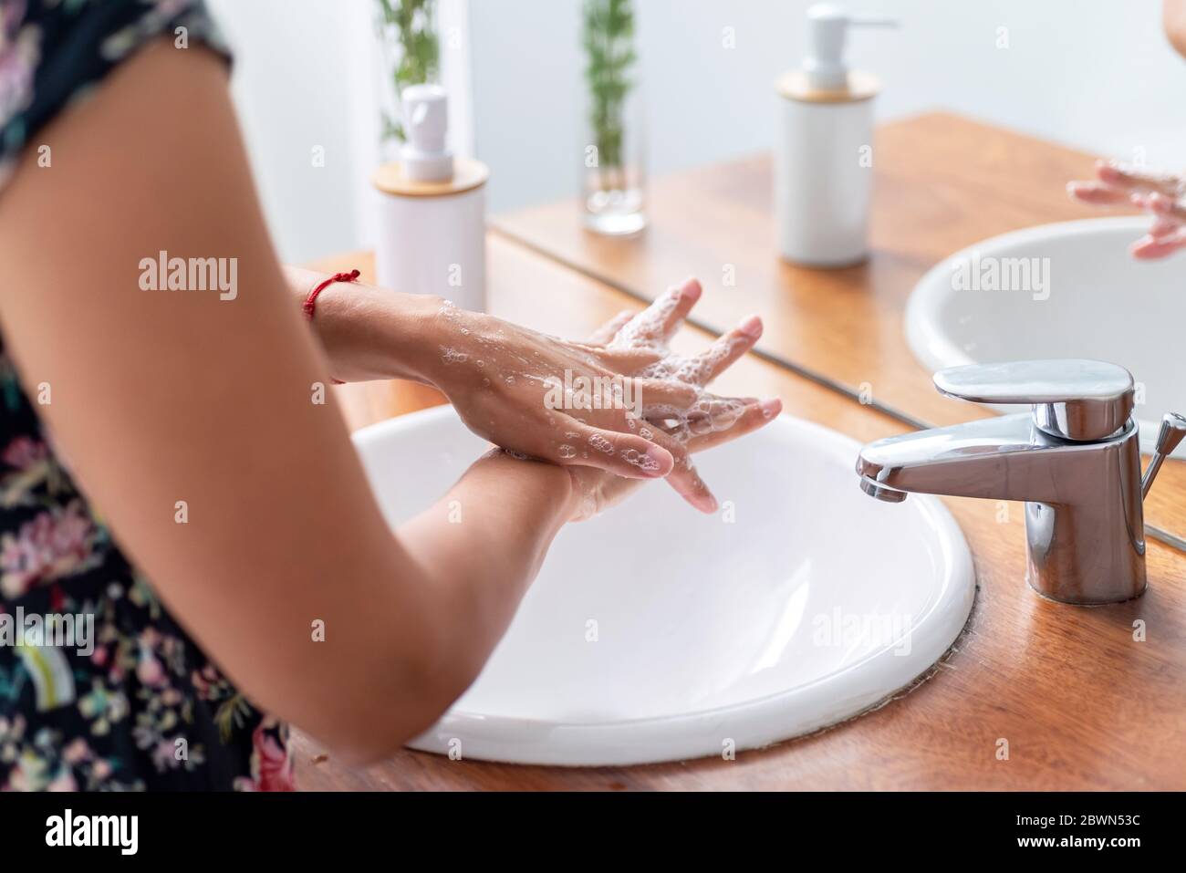 Detail of Woman's hands using soap and washing hands under the water ...