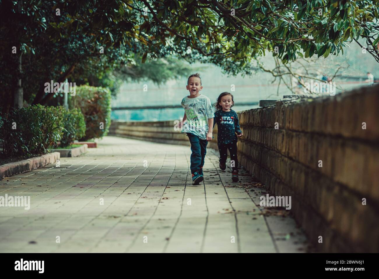 Two happy children run forward Stock Photo - Alamy