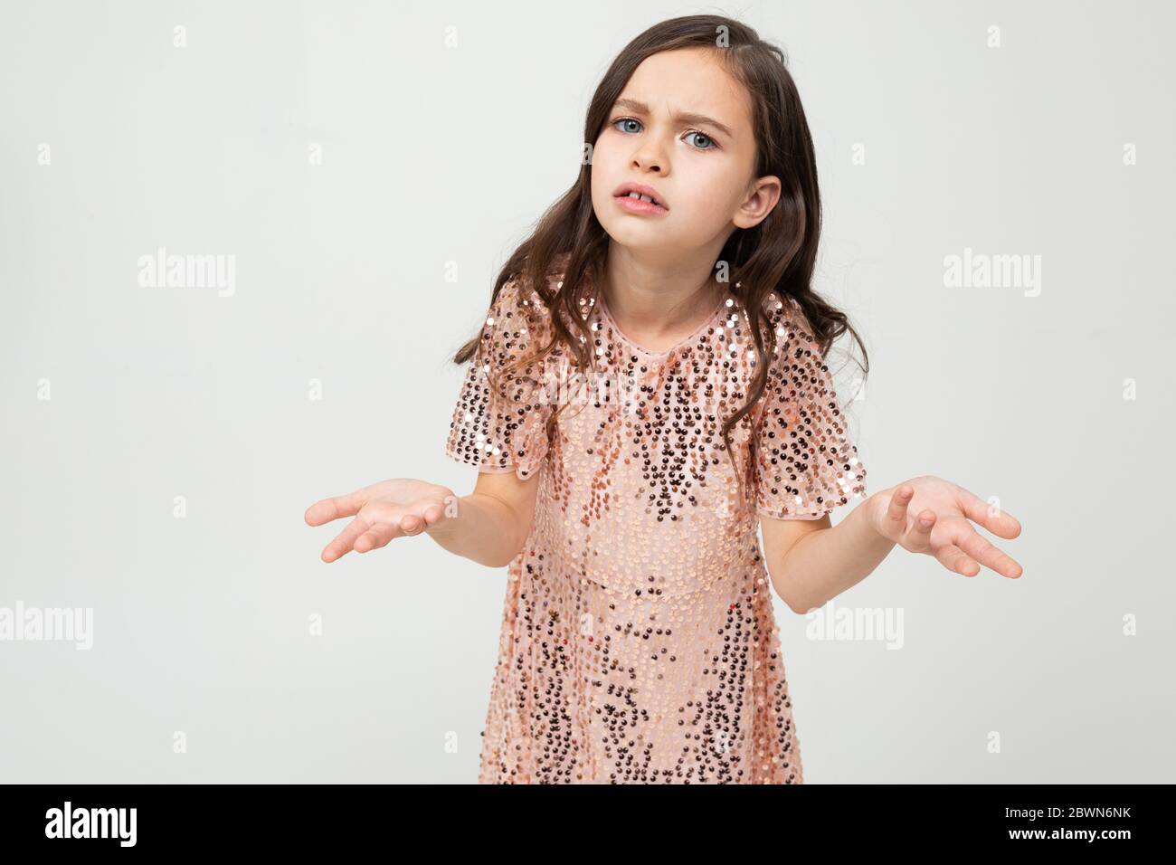 cute offended teenager girl shiny dress indignant on a white studio ...