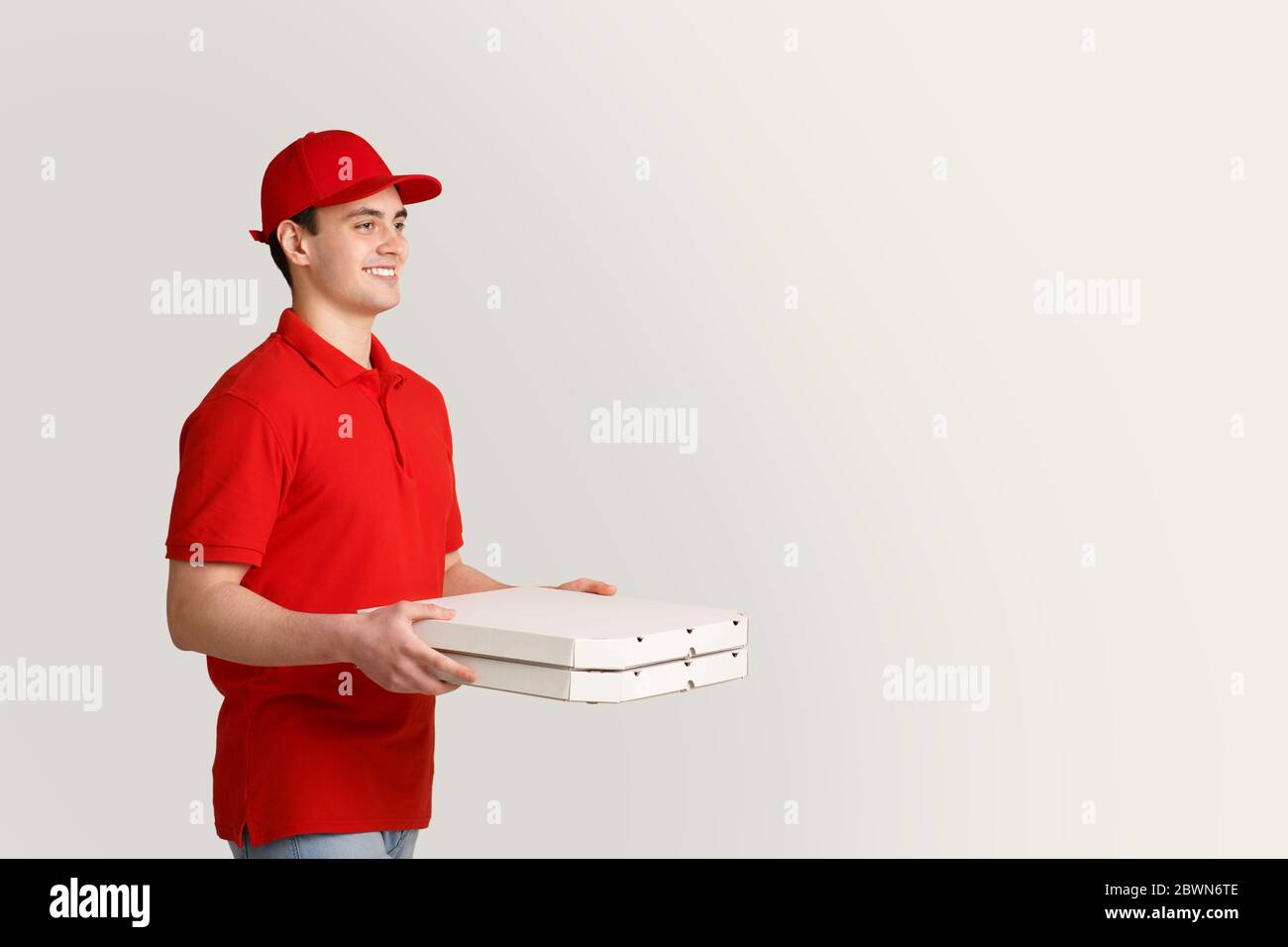 Man in uniform brings box hi-res stock photography and images - Alamy
