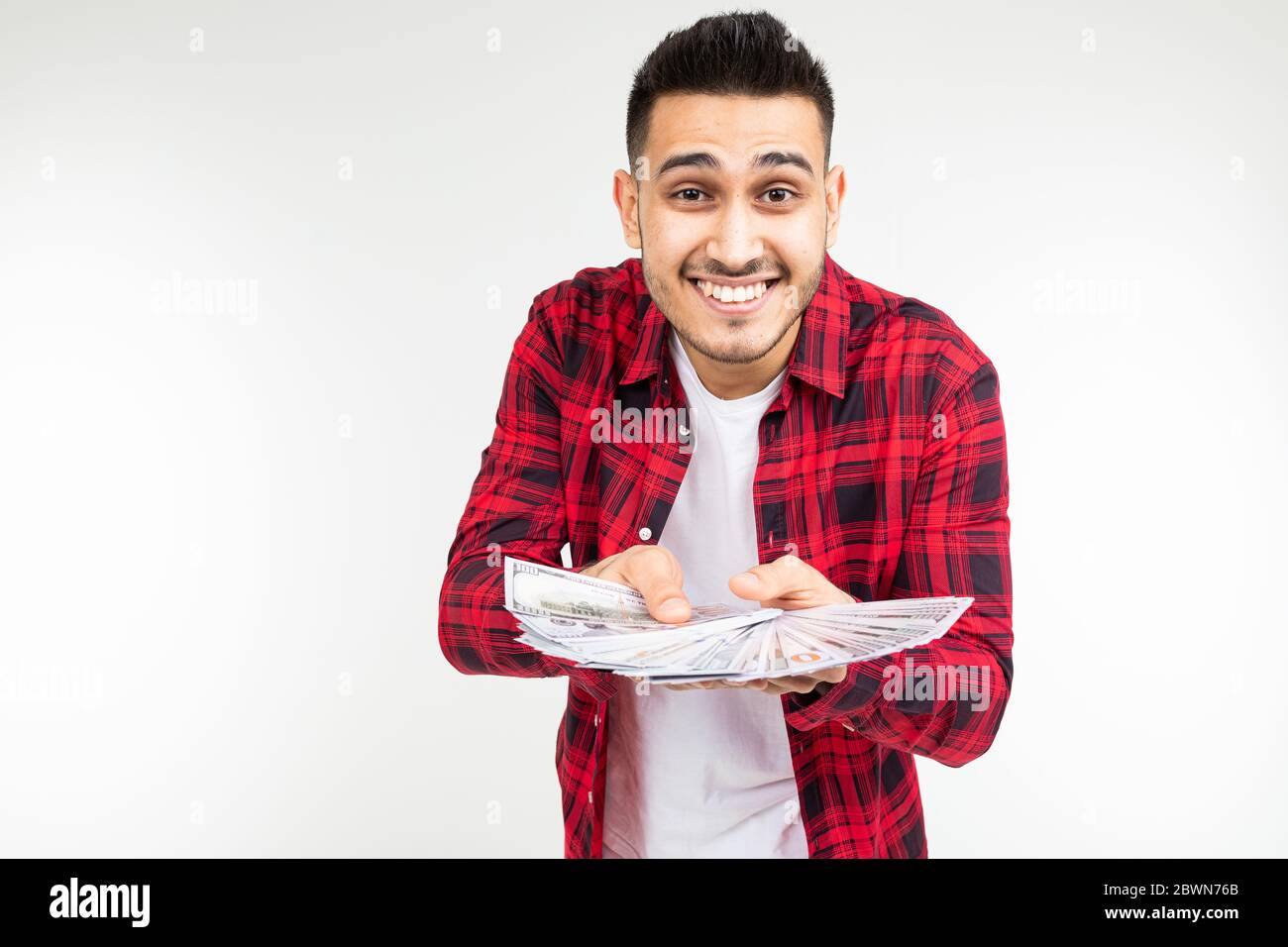 joyful man boasting a prize holding out money on a white background ...