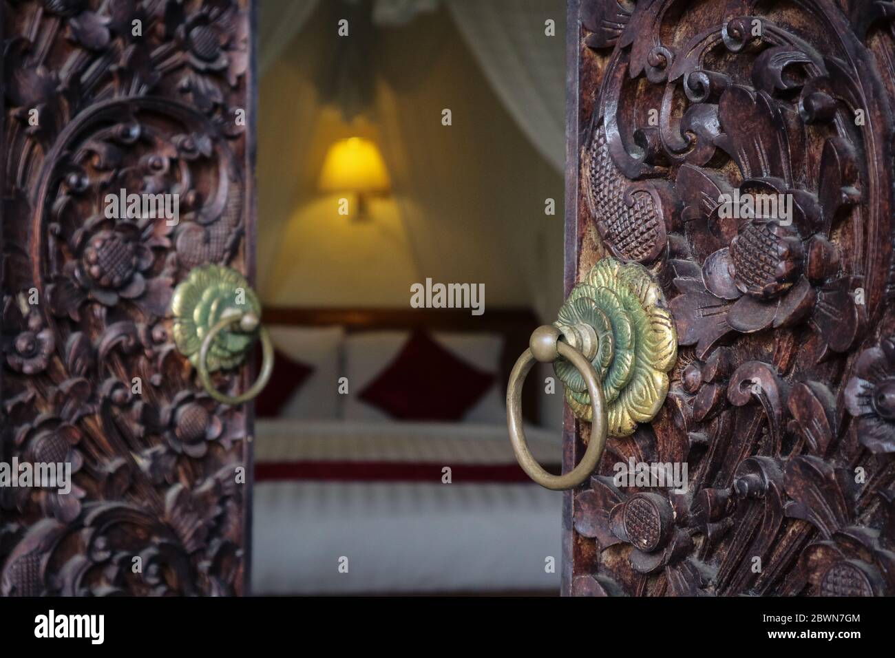 Traditional balinese bed with canopy. View through the opening of ...