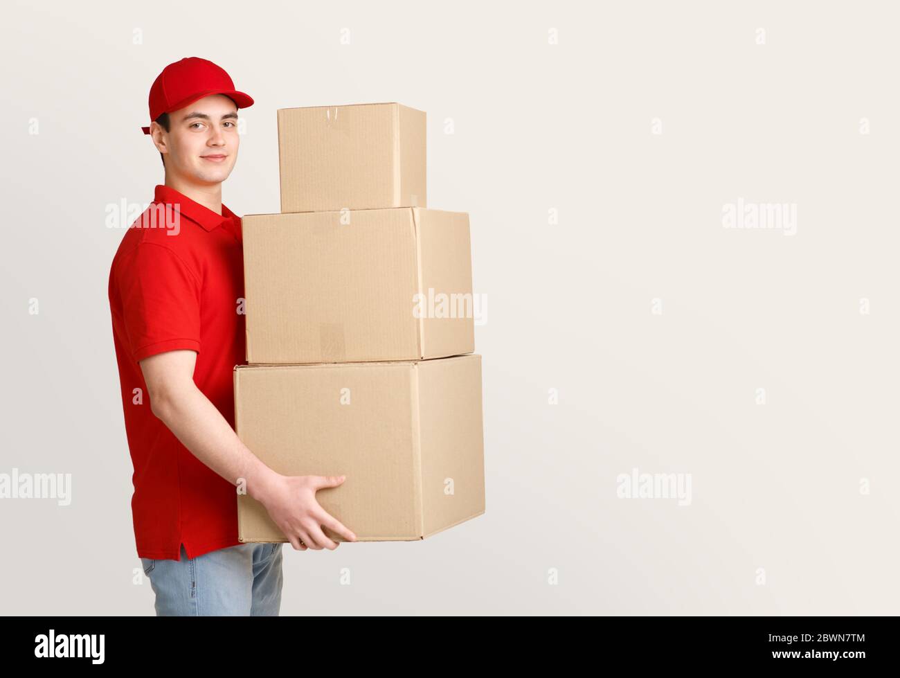 Delivery of order from online store. Courier in uniform holds many big ...