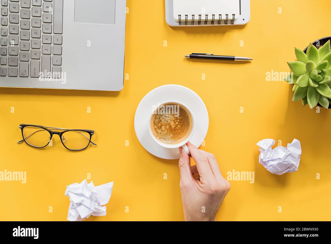 Bright yellow table workplace concept Stock Photo - Alamy