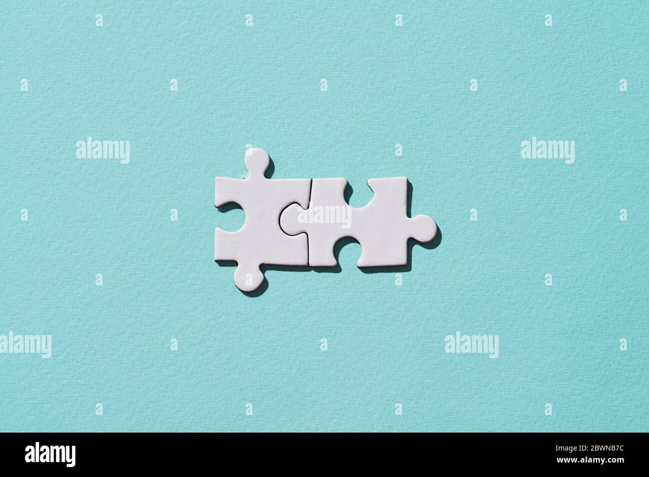 Two connecting puzzle piece. Concept of connection Stock Photo - Alamy