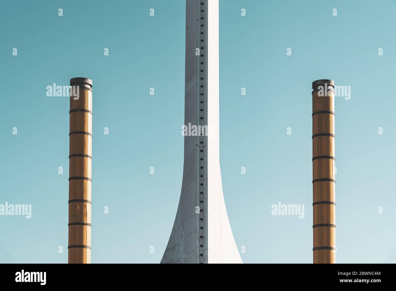 Detail of the base of a white communications tower surrounded by two ...