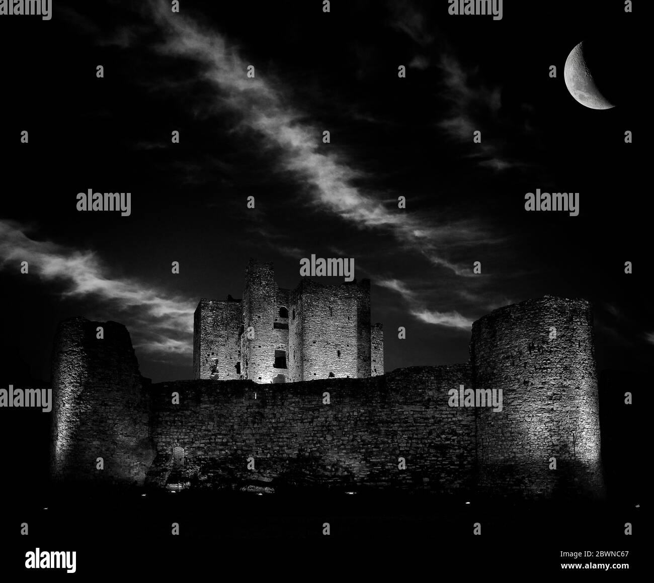 The flood lit walls of Trim Castle, a Norman castle on the River Boyne ...