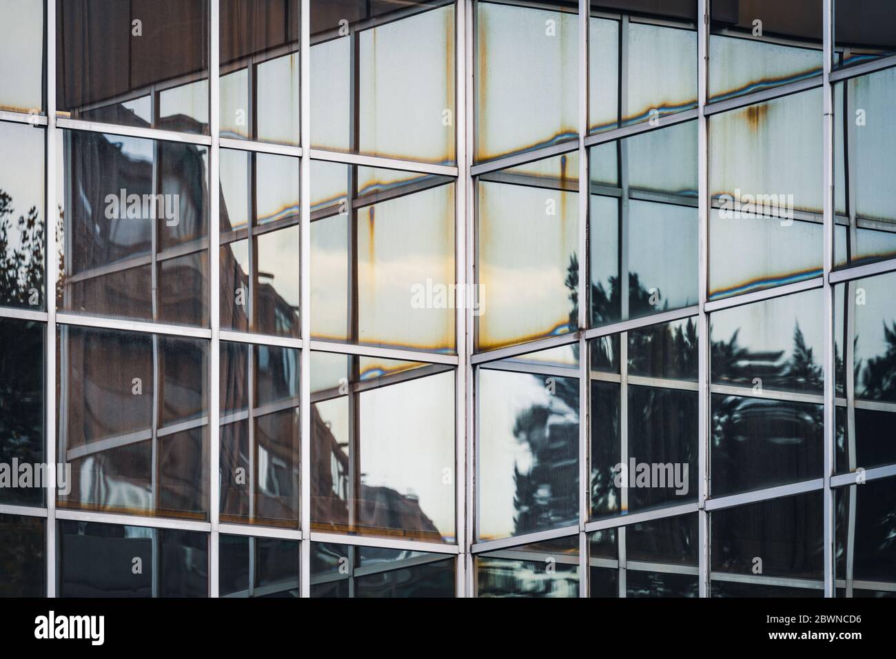 Reflections on the corner of the glass facade of an office building ...