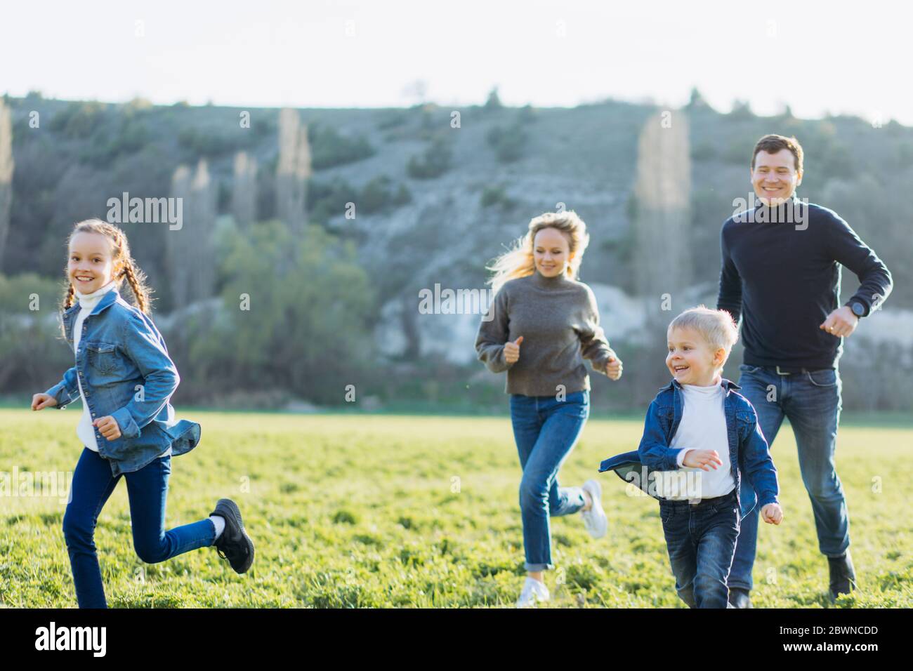 Family running across field together hi-res stock photography and ...