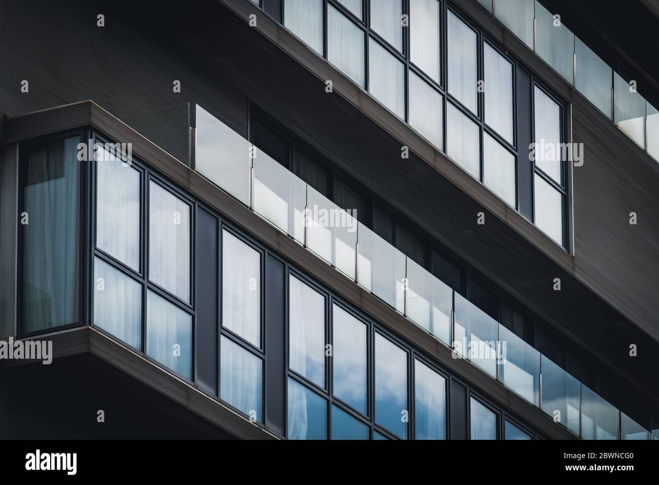 Architecture detail of the glass balconies of a minimalist urban ...