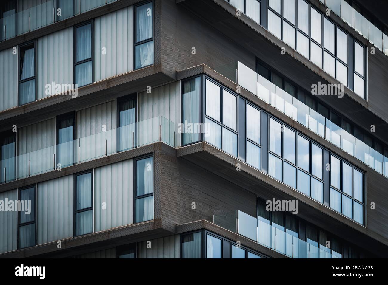 Architecture detail of the glass balconies of a minimalist urban ...