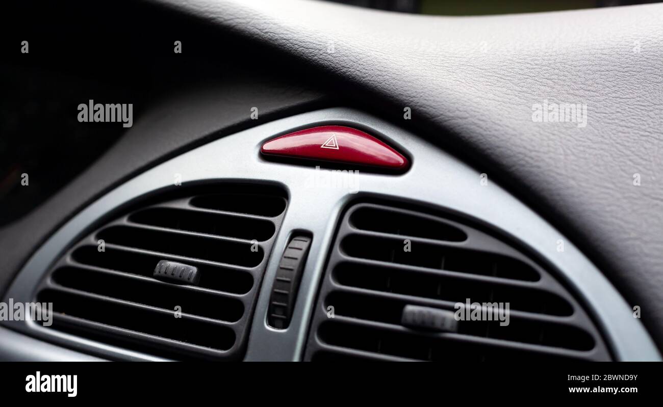 Simple red hazard warning lights button on car dashboard, triangle ...