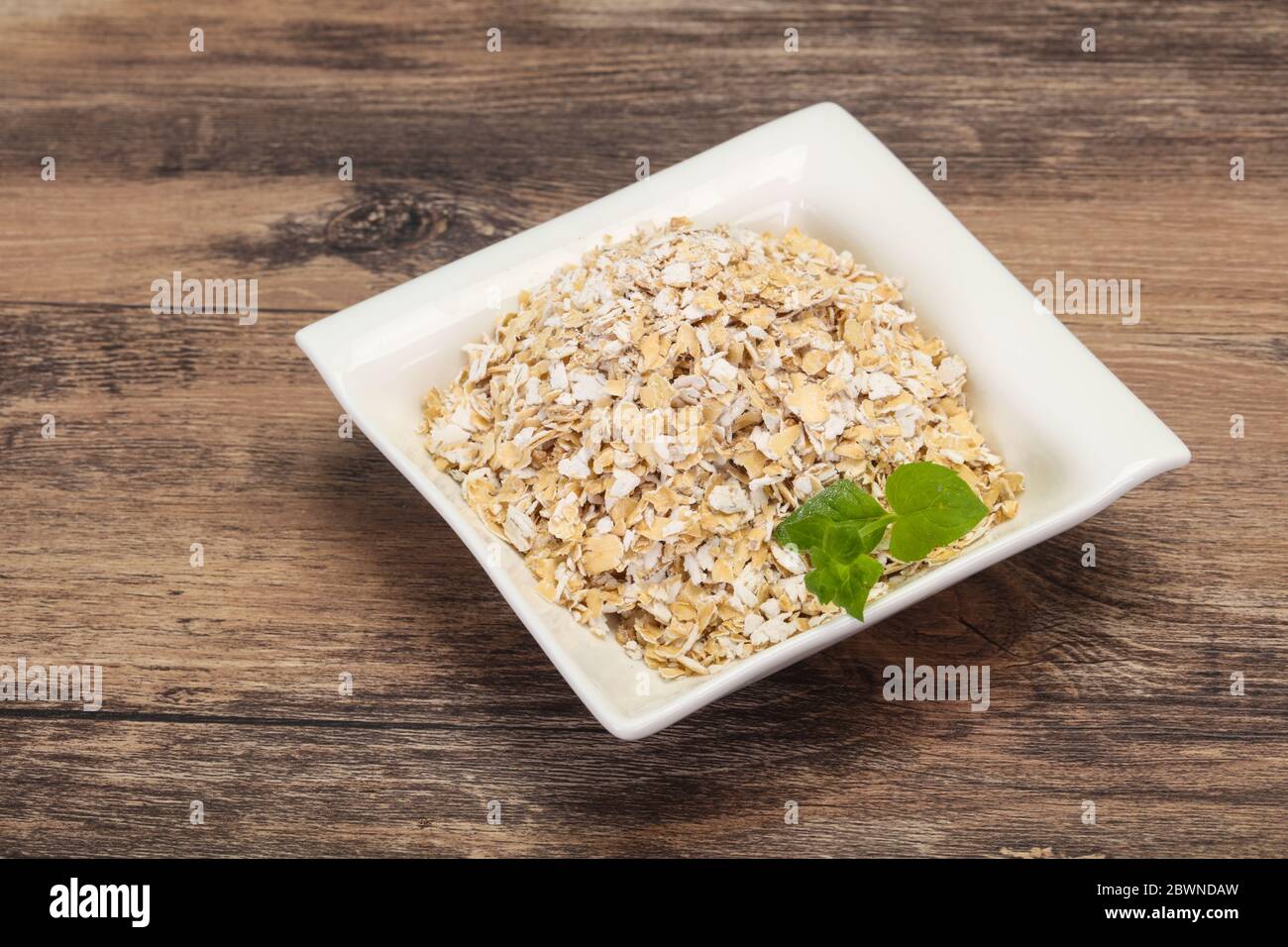 Raw oats in the bowl for breakfast Stock Photo - Alamy