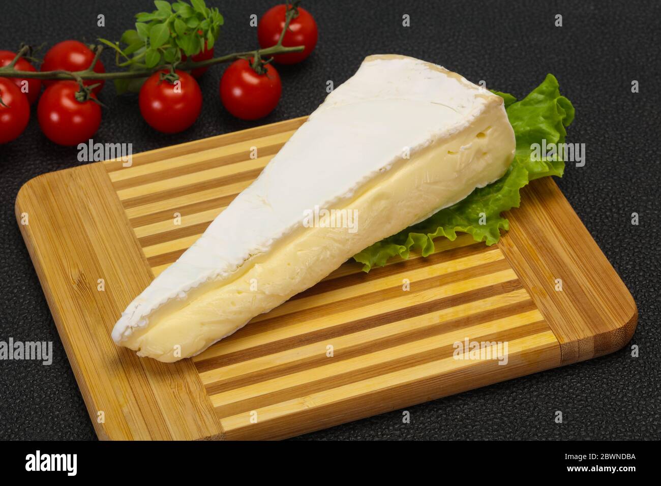 Brie cheese triangle served salad leaves Stock Photo - Alamy