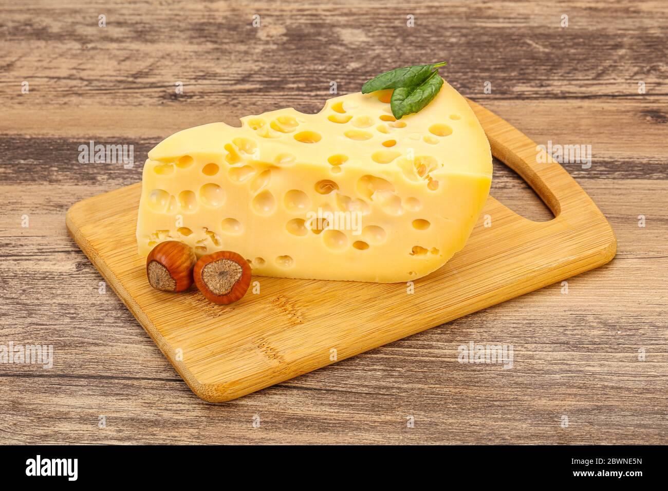 Maasdam cheese - dairy yellow triangle with holes Stock Photo - Alamy