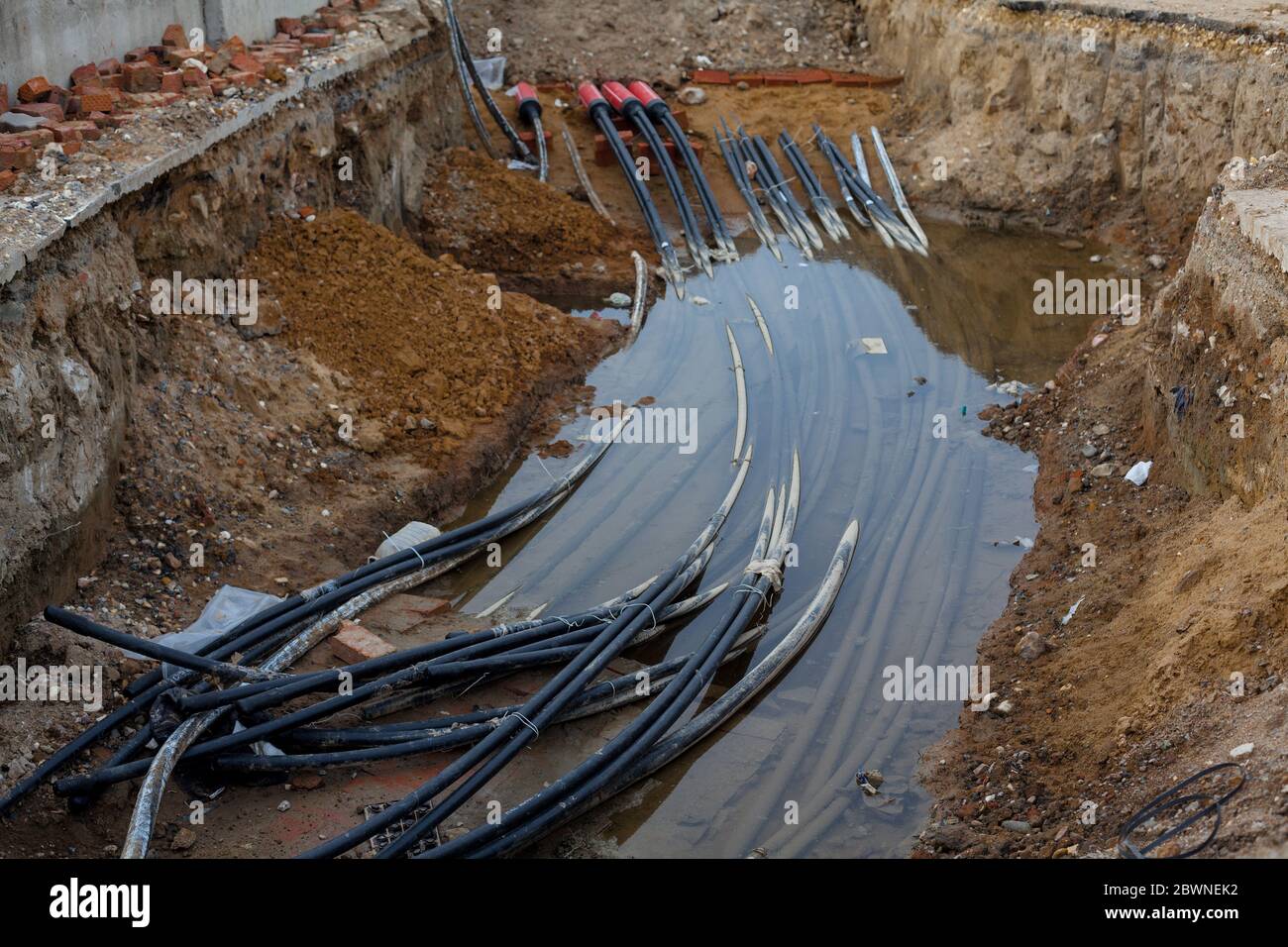 Cable laying. Construction works. Cable in subsoil water Stock Photo ...