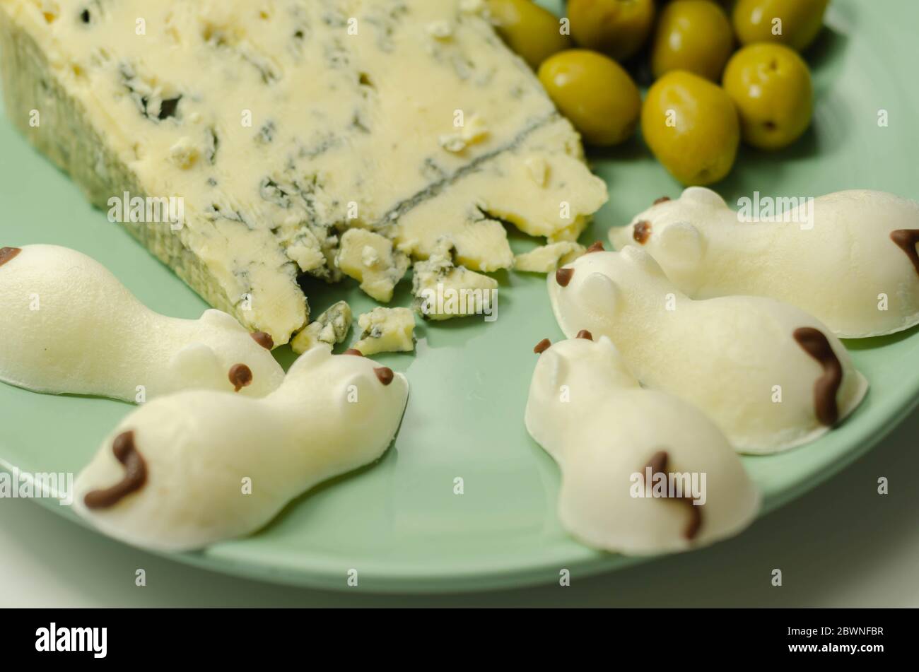 Full fat soft blue veined cheese with olives and snacks in the shape of ...