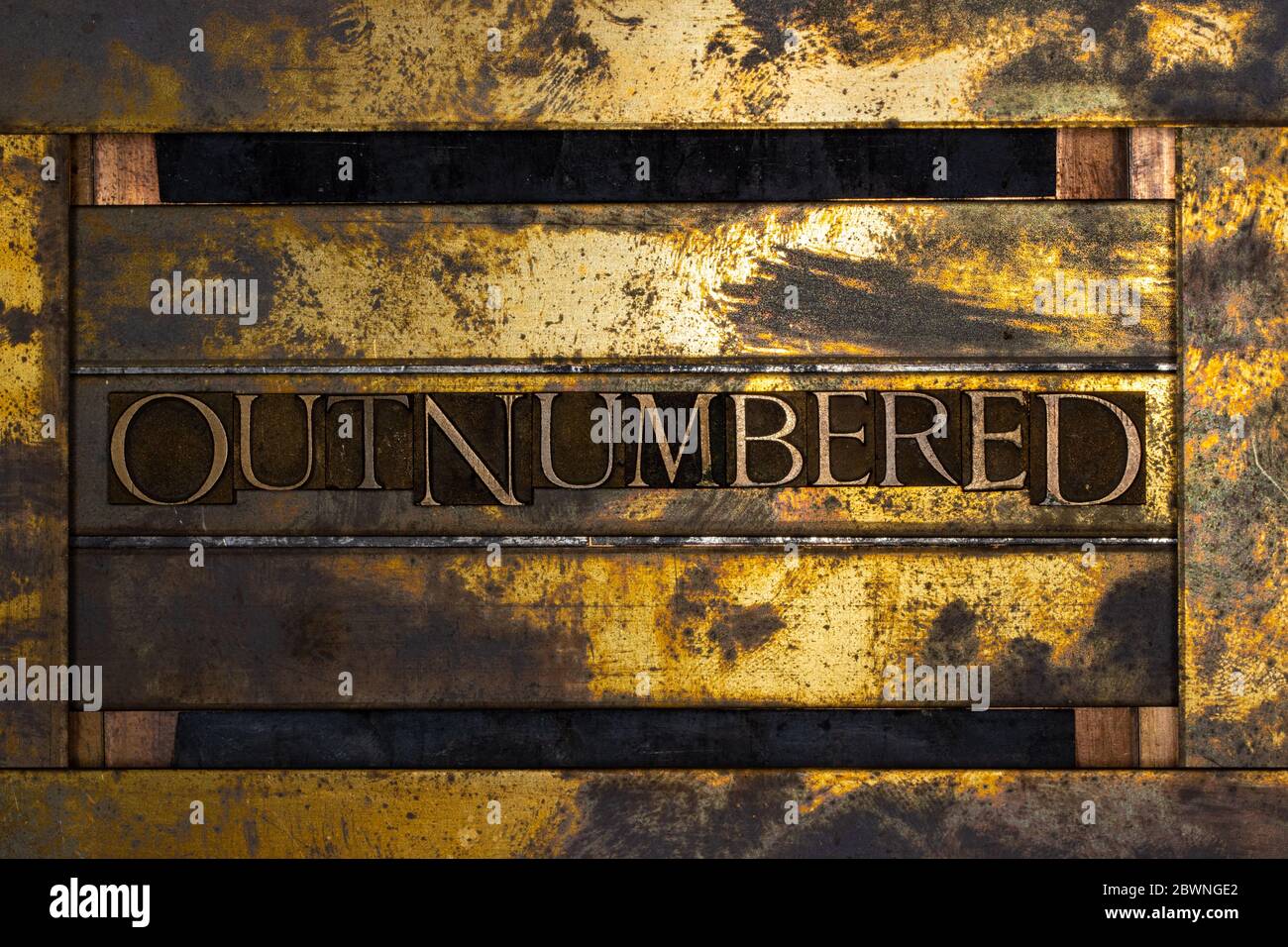 Photo of real authentic typeset letters forming Outnumbered text on ...