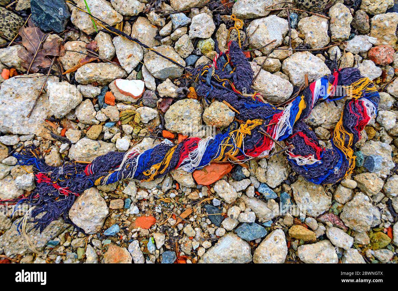 wet bundle of colorful threads on a ground covered by construction ...