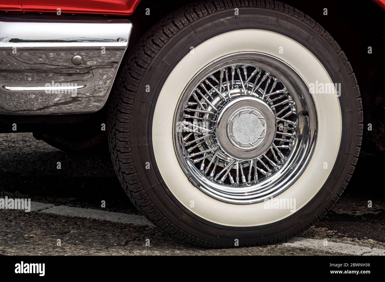 Shiny chrome spoked wheel disk with painted in white tire of red old ...