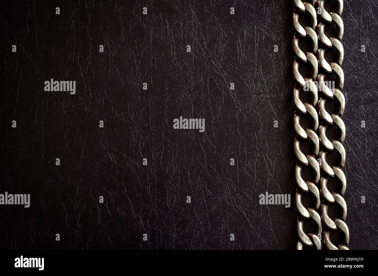 Metal chain on a dark background. Two rows of wicker chain on a ...