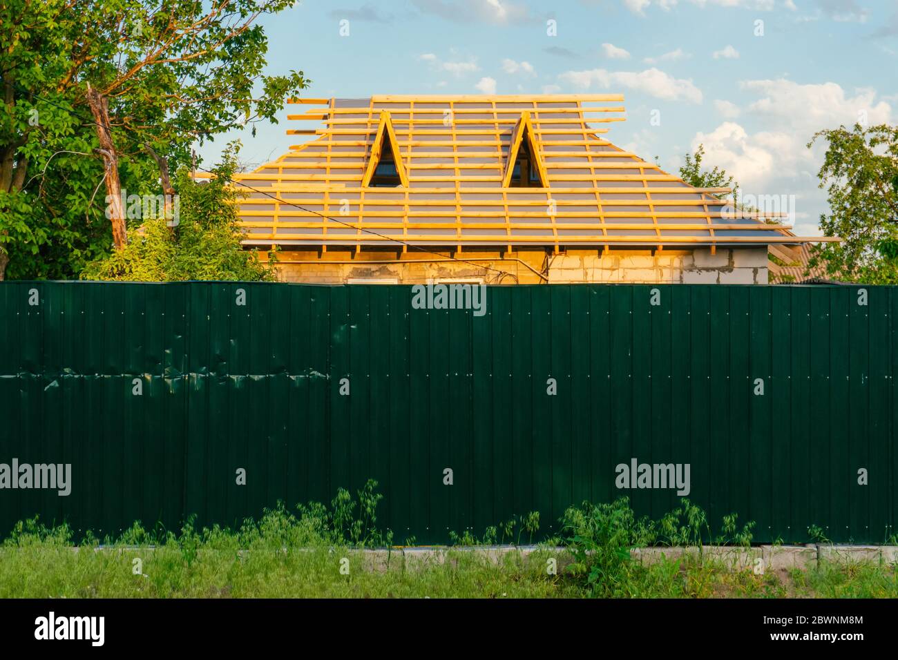 Construction of a country house, roof repair. House, plot with green ...