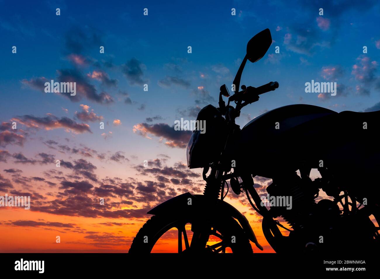 Motorcycle on a beautiful sunset evening sky Stock Photo - Alamy
