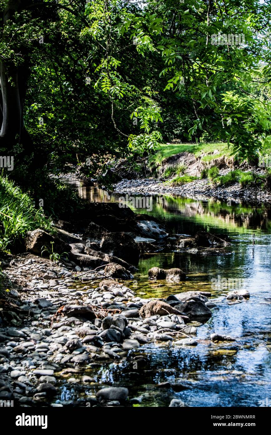 Trickling stream through he village of Grasmere in the Lake District ...