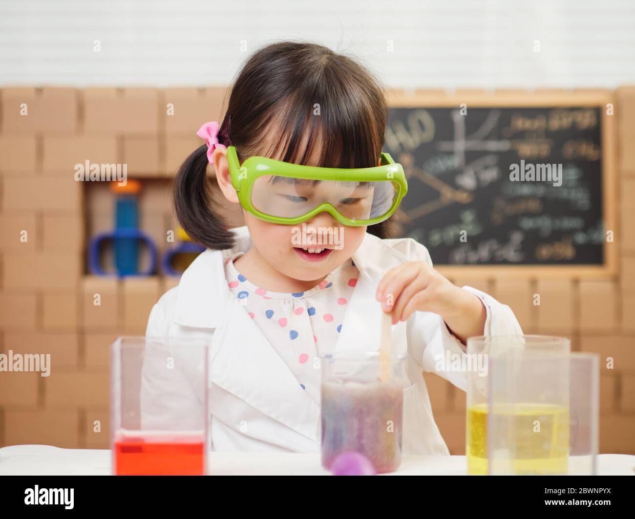toddler girl pretend play scientist role for homeschooling Stock Photo ...