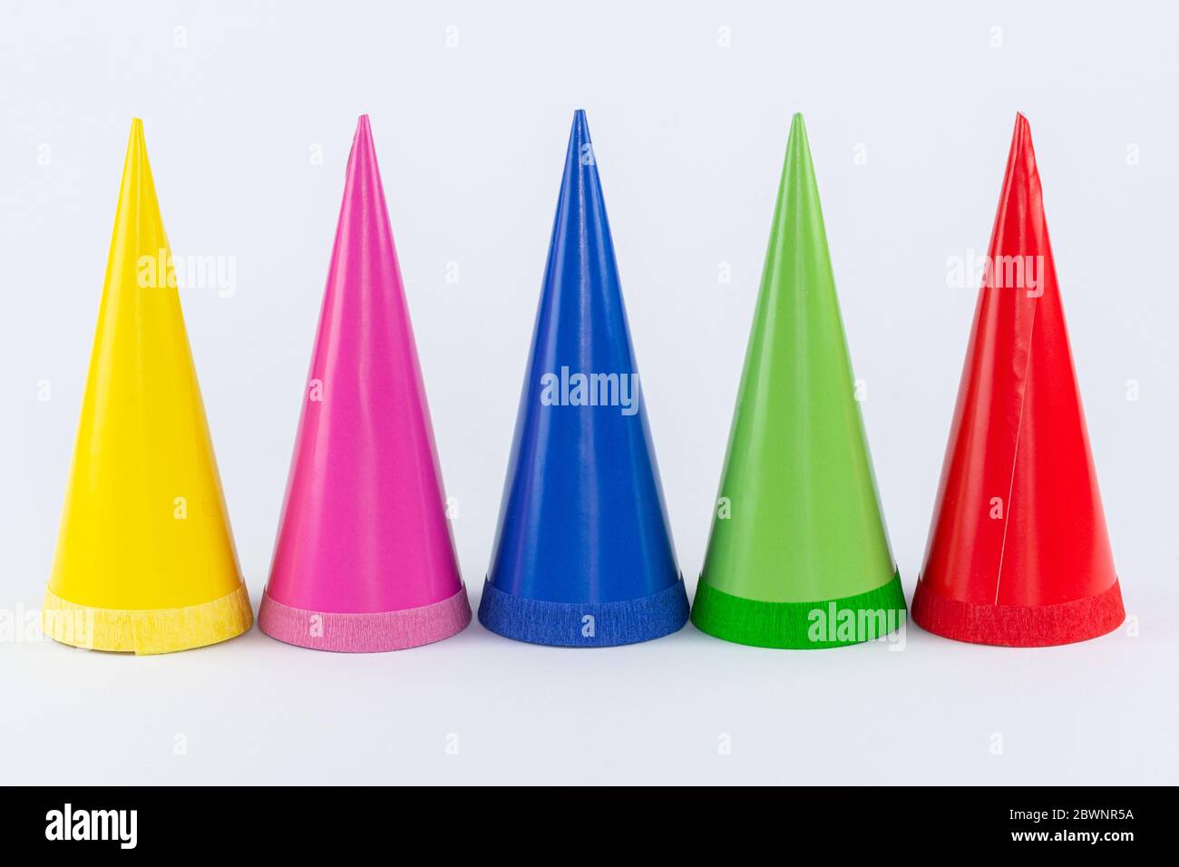 Colorful small sugar bags in five different colors standing on a light ...