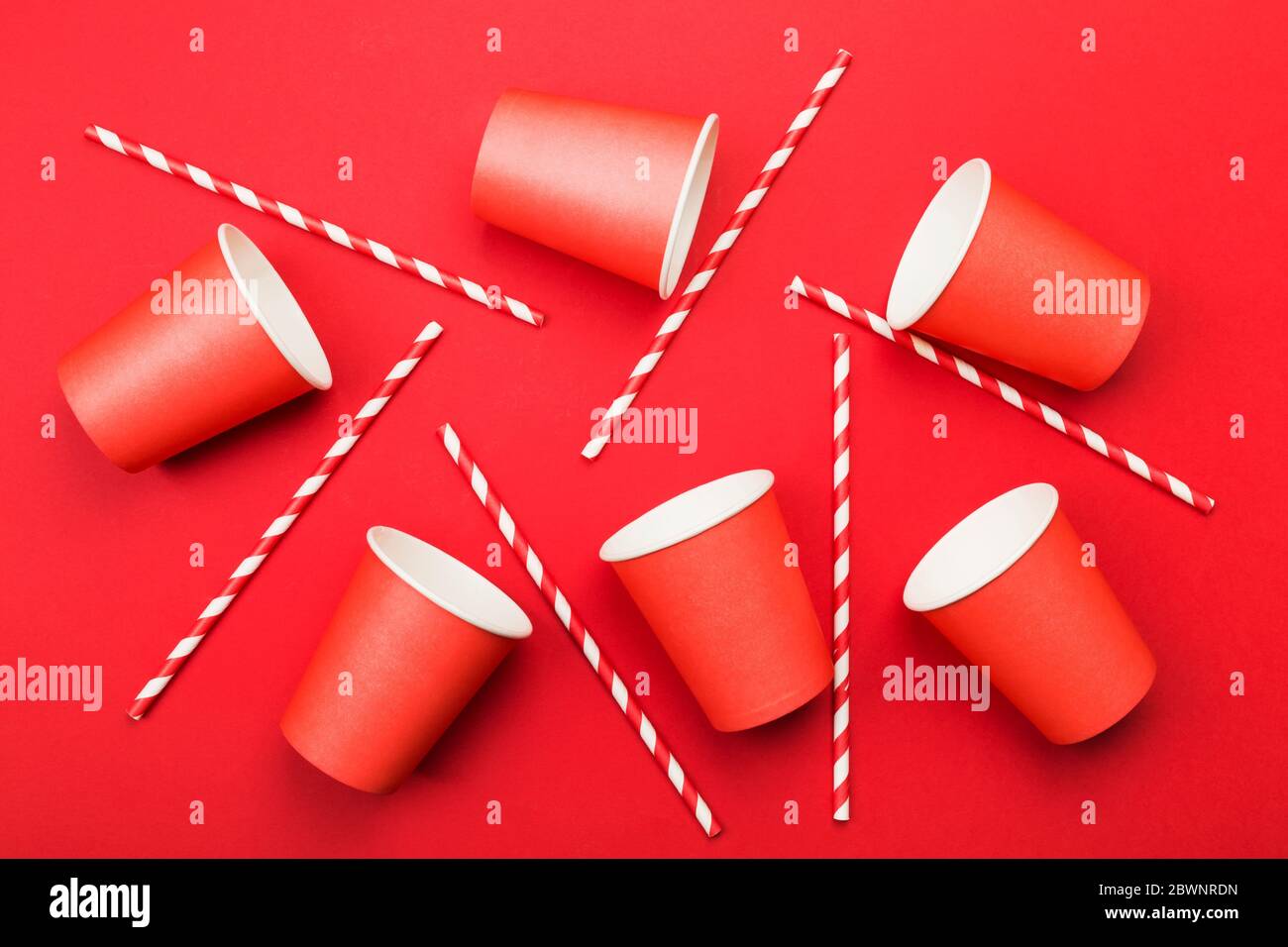 Red paper cups and red-white straw on red background. Top view Stock ...