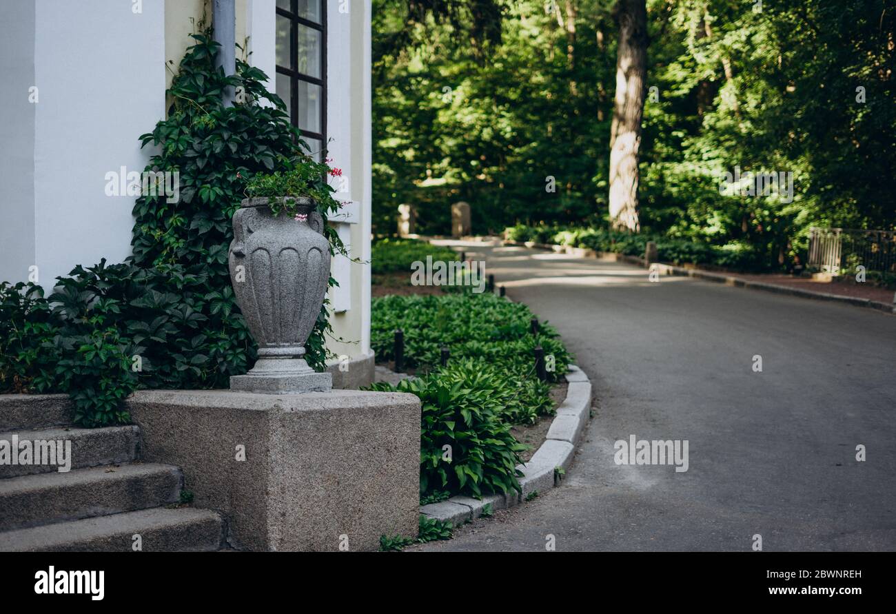 Uman, Ukraine. Stone vase with flowers at the entrance to the gazebo ...