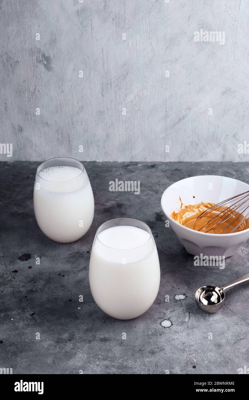 Popular drink Korean Dalgon coffee. Long spoon add lush whipped foam to ...