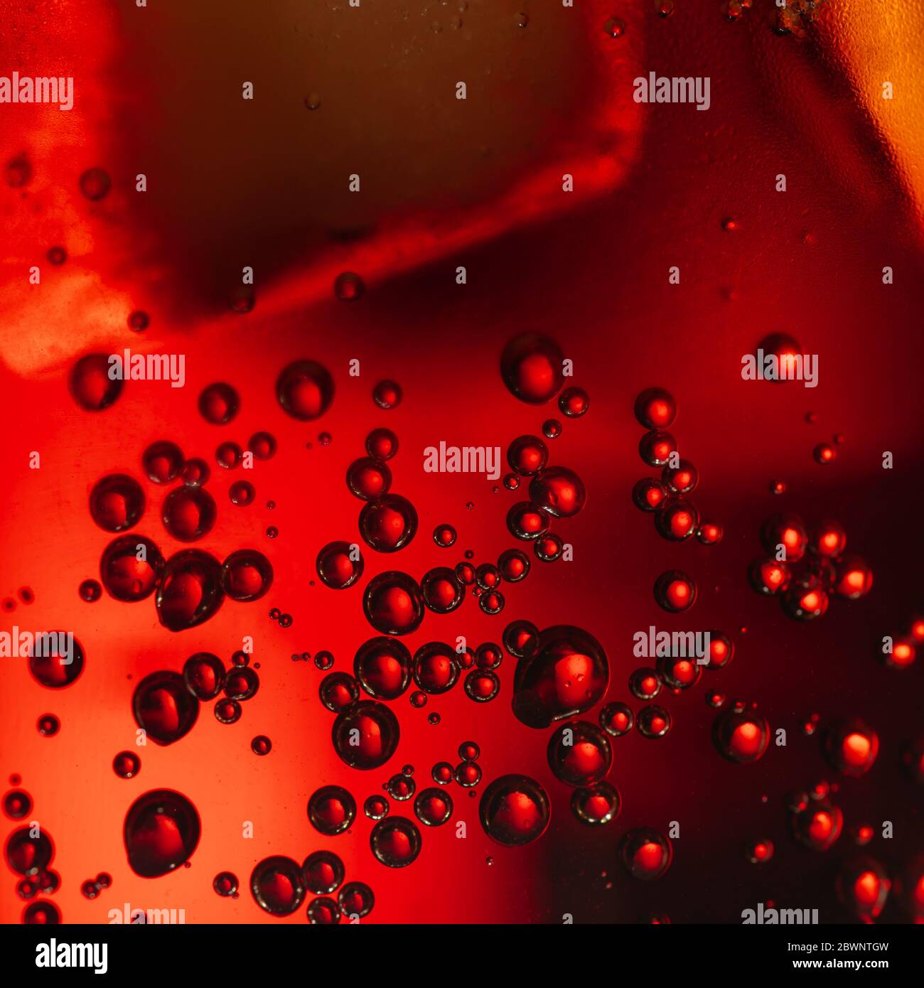 Fresh fizzy coke with bubbles and ice cubes background. Bubbly soda pop ...