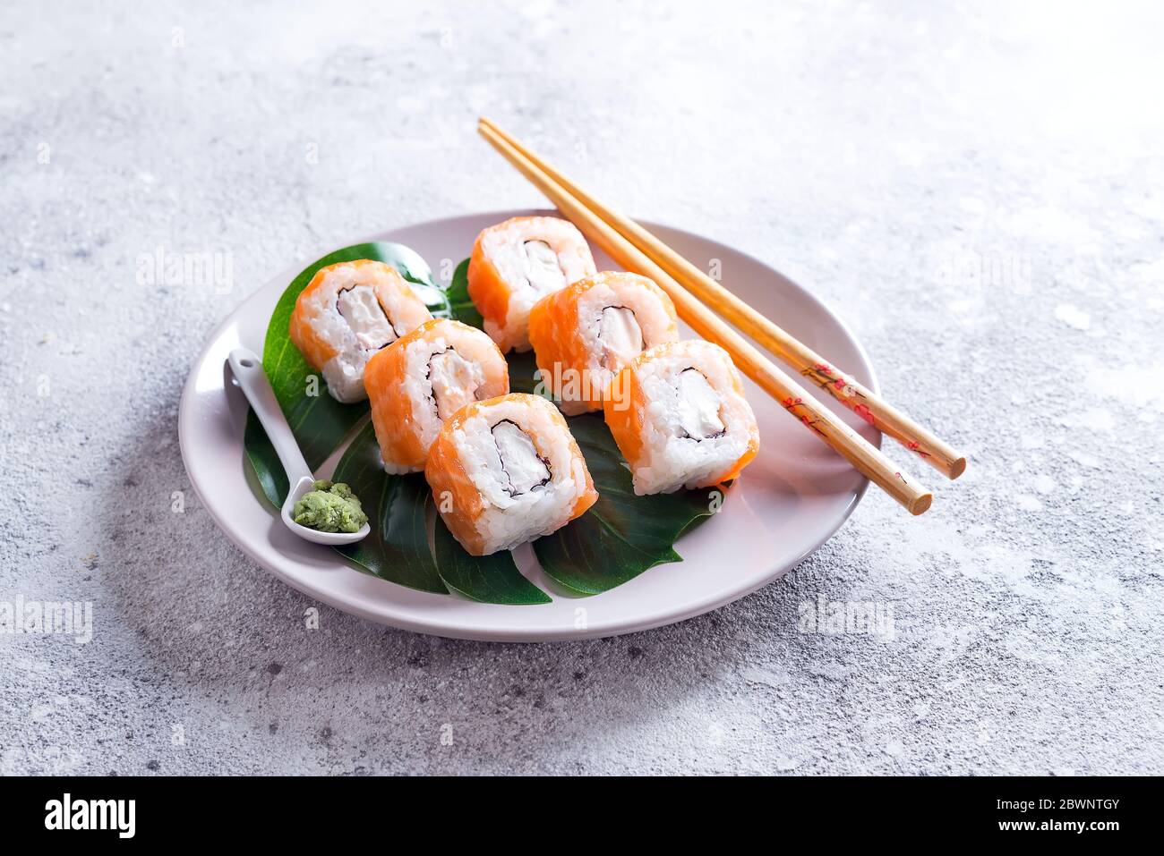 Philadelphia roll classic on a plate with chopsticks. Japanese sushi ...