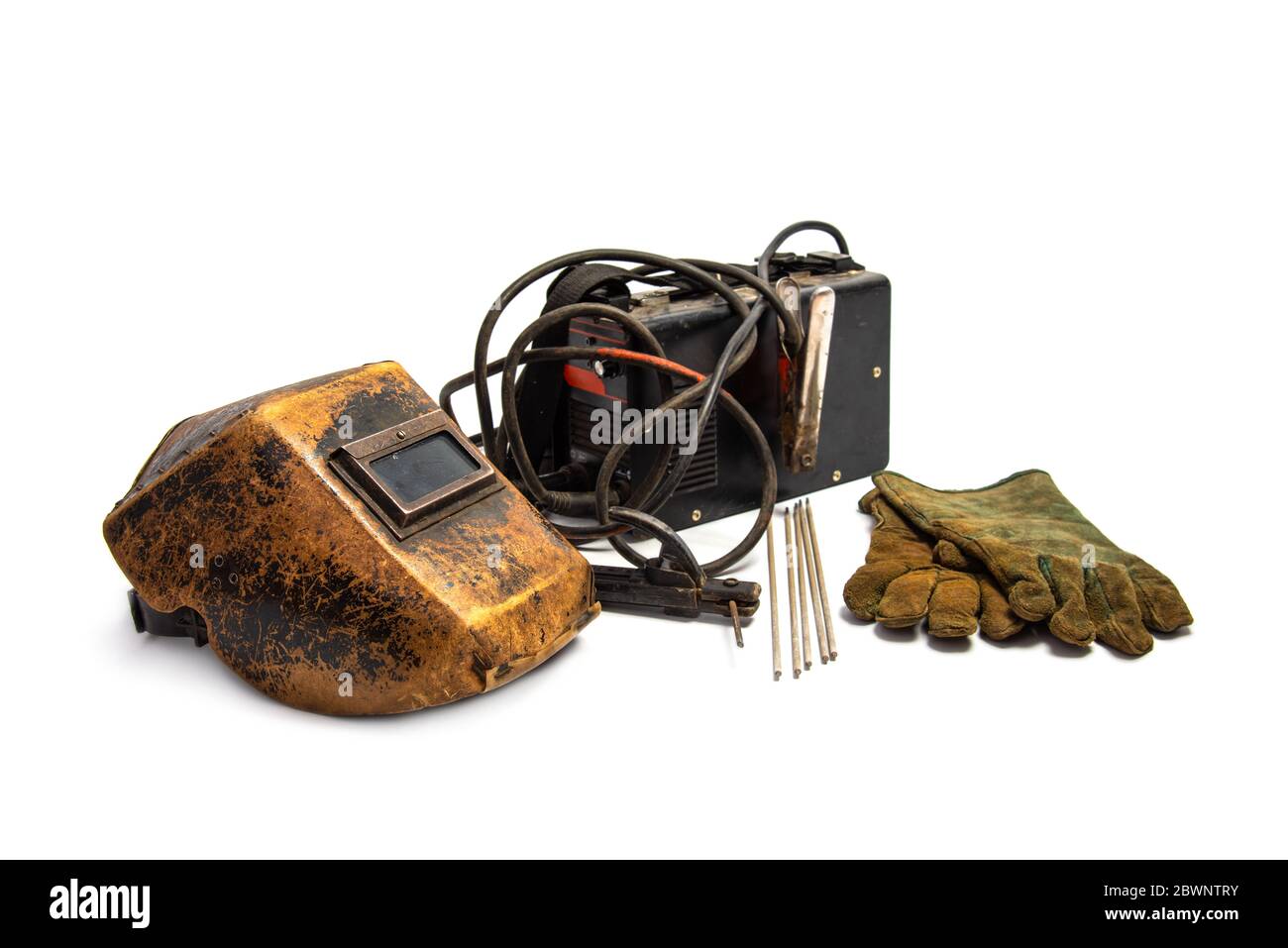 Aged welding mask with welding machine, protective gloves, and arc ...