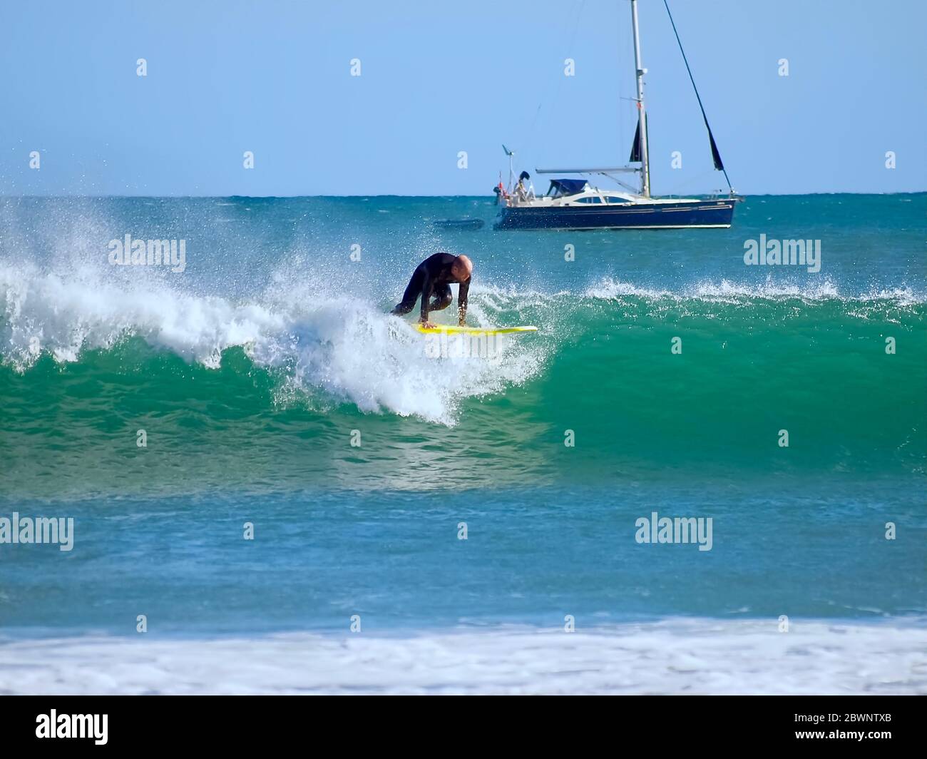 A surfer on his board on high waves Stock Photo - Alamy