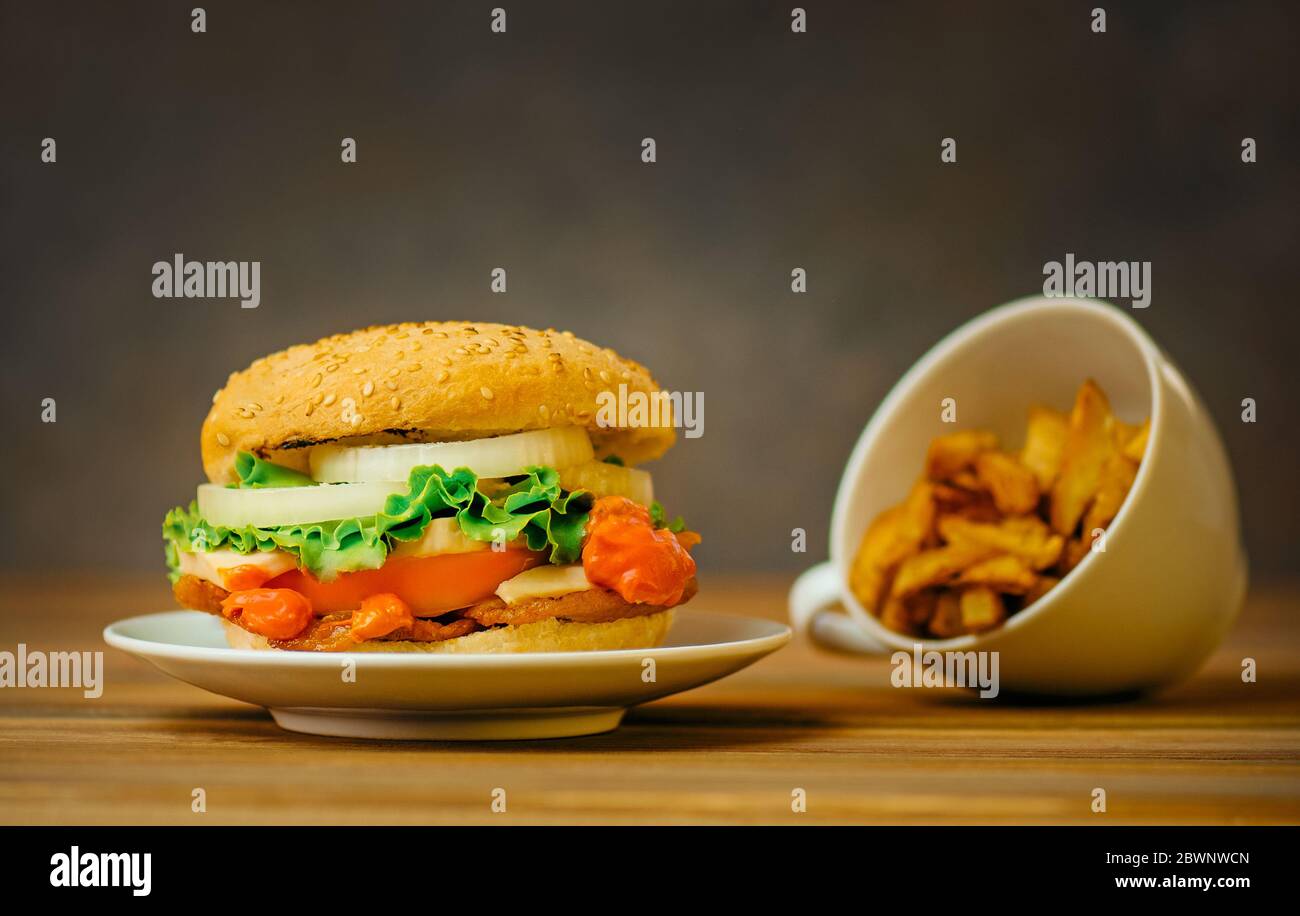 French fries and juicy meat burger with beef, cheese, tomatoes ,lettuce ...