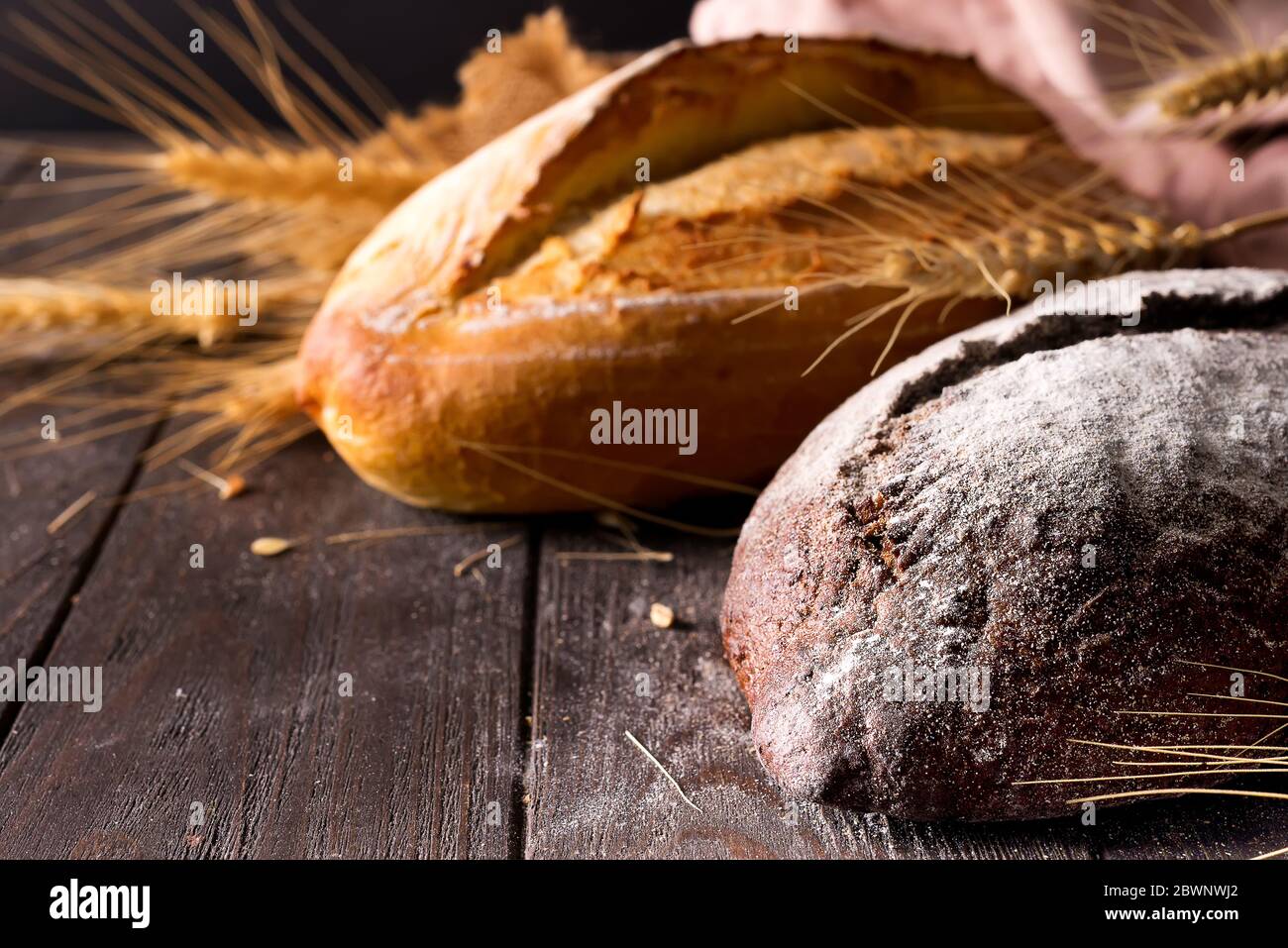 Rustic bread roll or french baguette, wheat and flour on wooden. Rural ...