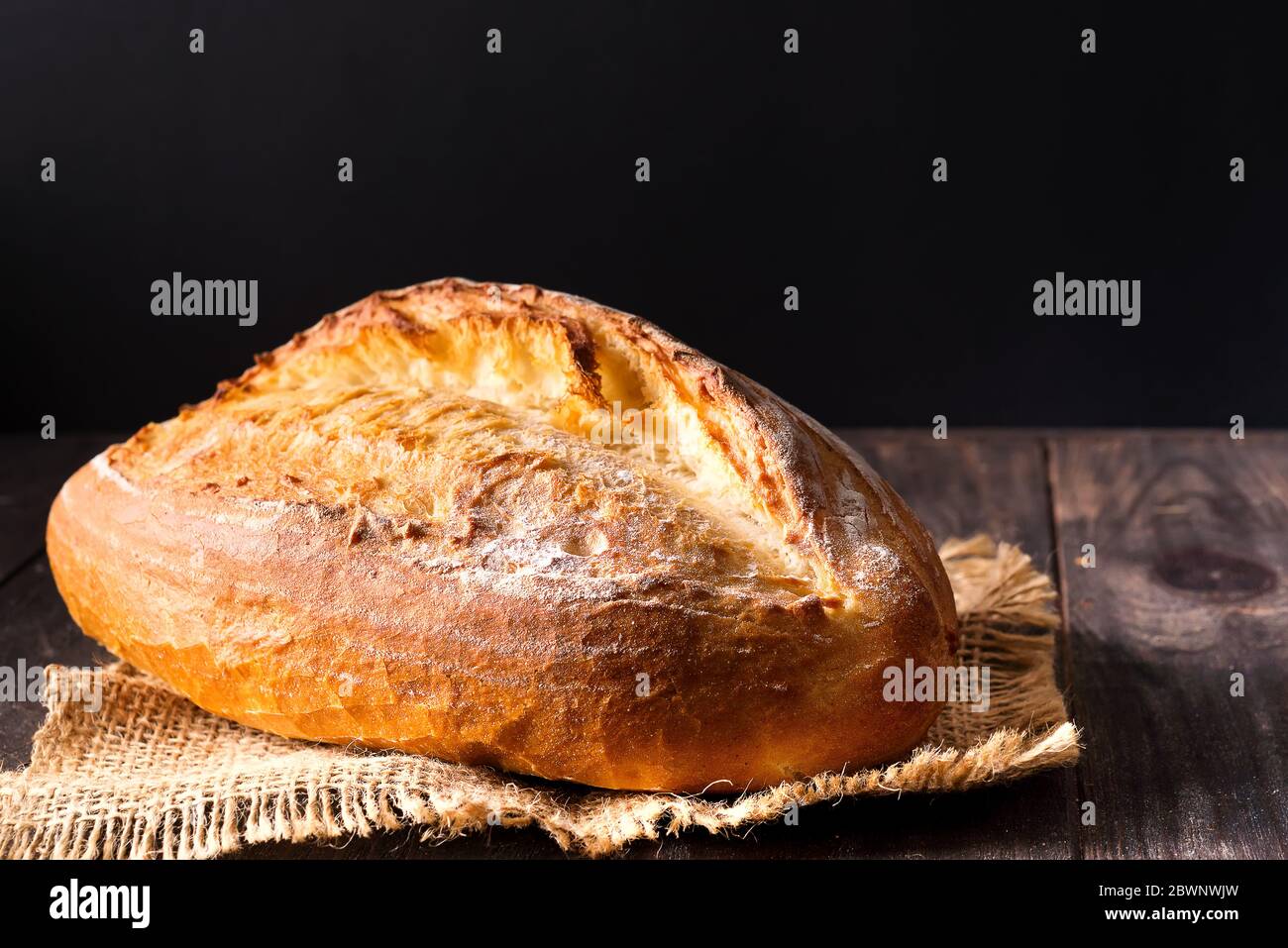 Rustic bread roll or french baguette, wheat and flour on wooden. Rural ...