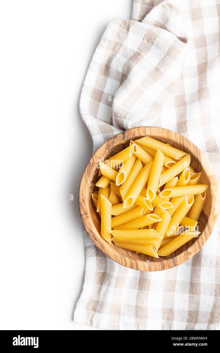 Uncooked penne pasta. Dried italian pasta in wooden bowl isolated on ...