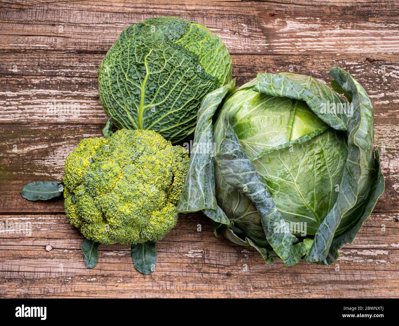 Three kinds of cabbage on old wooden background Stock Photo - Alamy