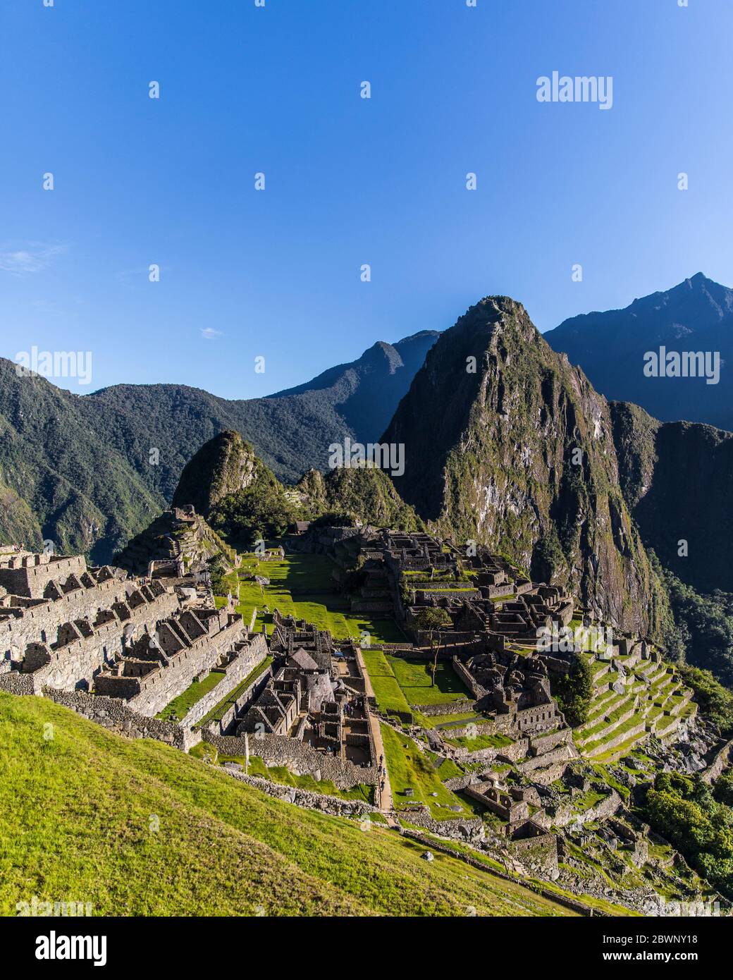 rock mountain green landscape blue sky inca ruins Stock Photo - Alamy