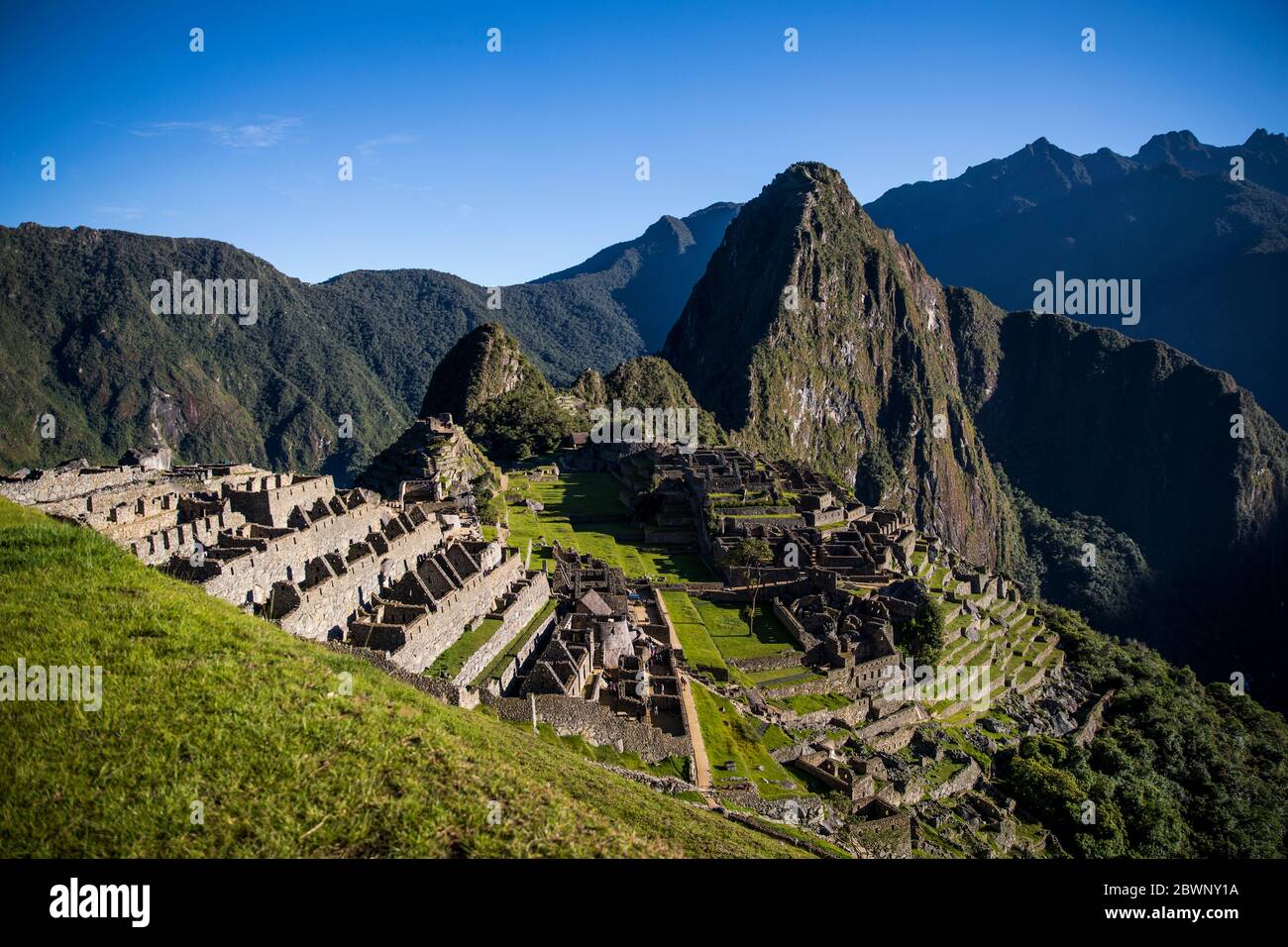 rock mountain green landscape blue sky inca ruins Stock Photo - Alamy