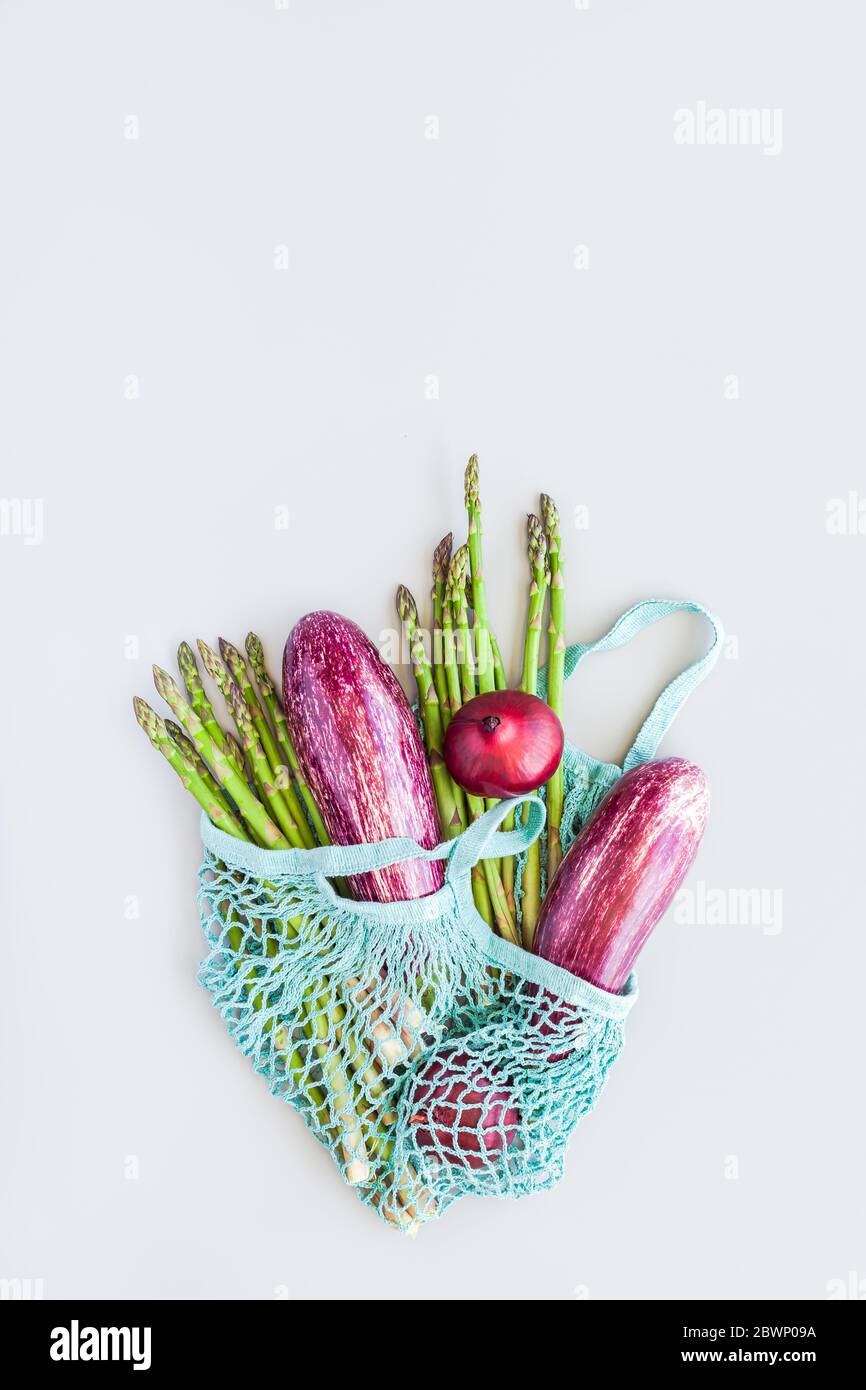 Fresh organic vegetables in blue eco reusable cotton mesh shopping bag ...